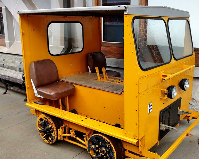 This charming maintenance vehicle, painted in cheerful yellow, once carried workers along the tracks&mdash;a miniature workhorse with outsized personality.