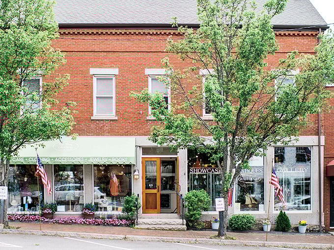 Brick storefronts with carefully curated window displays invite shoppers to discover local artisans and unique finds. Main Street shopping as it should be.