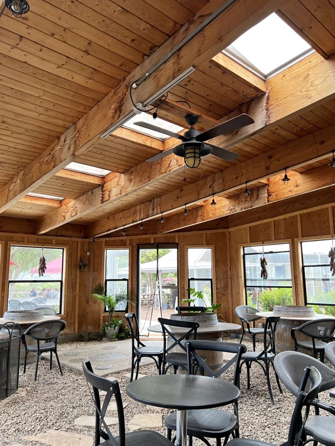 Natural light floods this airy space where wooden beams and casual seating create the perfect spot for afternoon wine tasting.