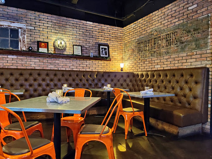 Exposed brick walls and leather booths create that sweet spot between rustic charm and urban cool&mdash;quintessential modern smokehouse vibes.