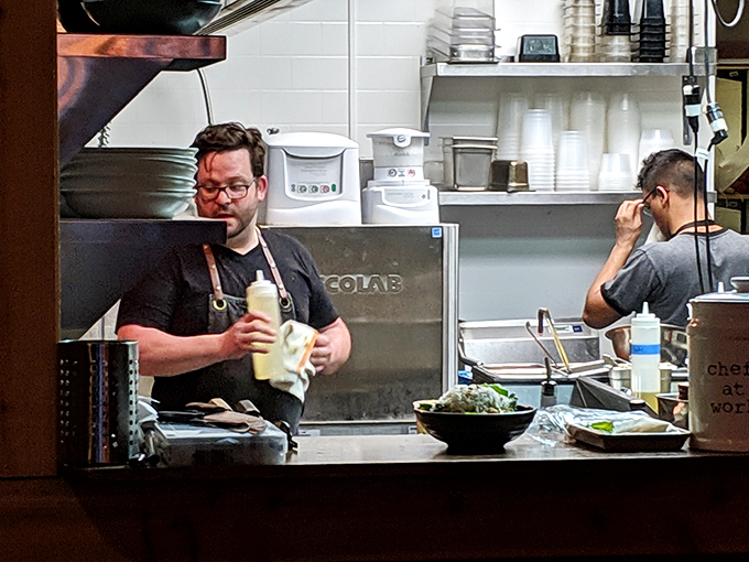 A glimpse into the kitchen reveals the wizards behind the curtain. Like watching Olympic athletes, but their sport is making you reconsider your relationship with food.