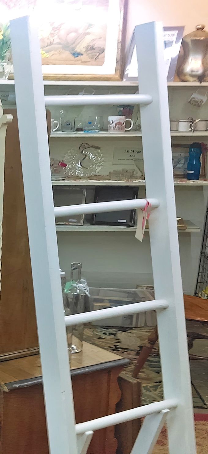 This charming white ladder isn't just for climbing&mdash;it's a clever display piece showcasing mugs and small treasures.