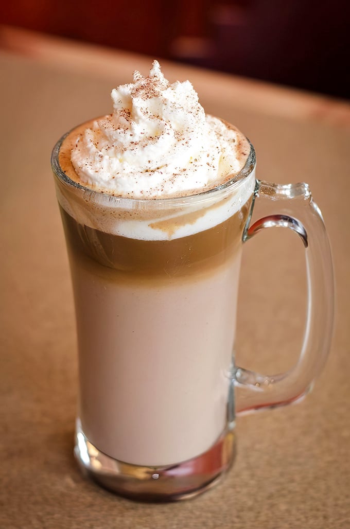 This layered latte isn't just coffee&mdash;it's a morning hug in a mug, topped with a cloud of whipped cream dusted with cinnamon.