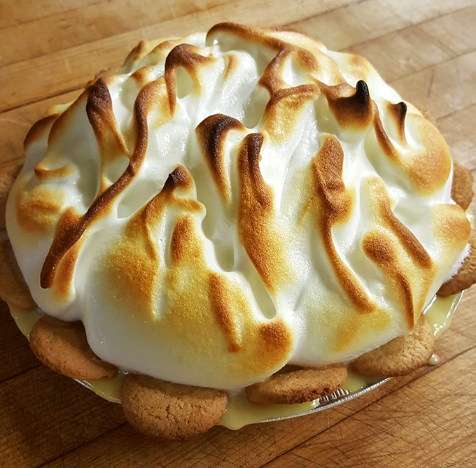 Lemon meringue pie with peaks so perfectly browned they deserve their own mountain range on a map of Dessert Country.