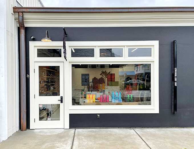 This charming storefront invites passersby to step inside and discover treasures from yesteryear, its entrance adorned with patriotic bunting and blooming geraniums.