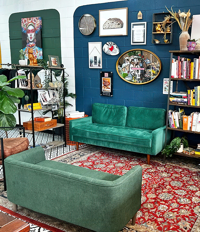 The lounge area, with its emerald velvet couches and eclectic wall art, offers a stylish spot to contemplate your next pastry conquest.