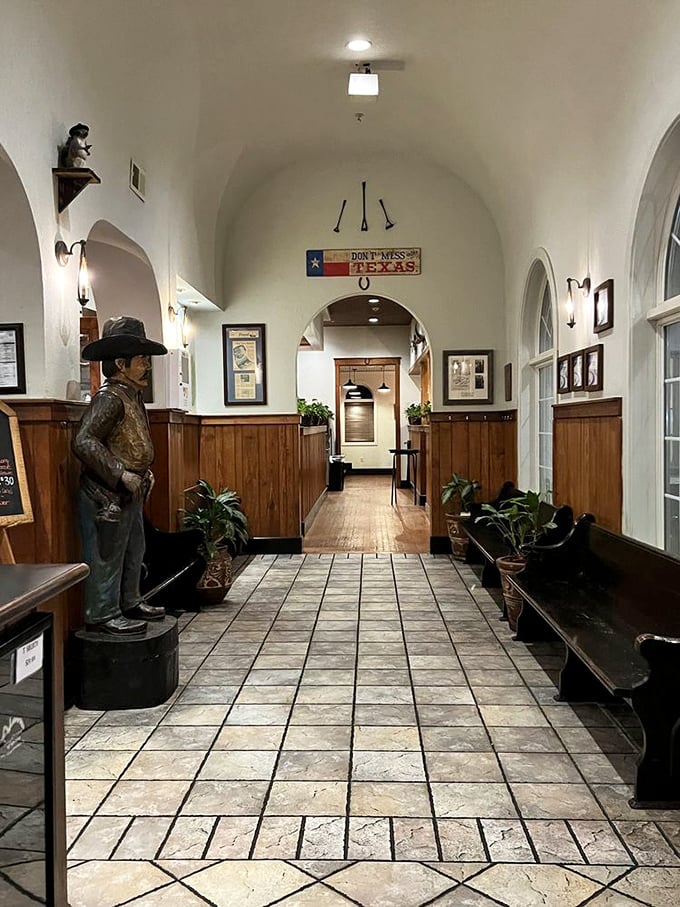The entrance hallway, complete with cowboy statue and "Don't Mess With Texas" sign, sets the tone for the Southwestern experience that awaits.