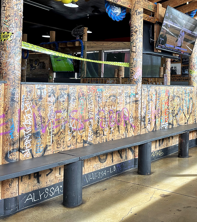 The lounge area features graffiti-covered wood paneling that tells the story of countless satisfied customers who left their mark literally.