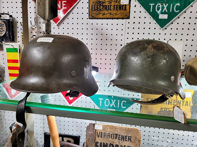 History preserved under glass &ndash; these WWII-era helmets sit silently on display, artifacts from a global conflict now treasured by military collectors.