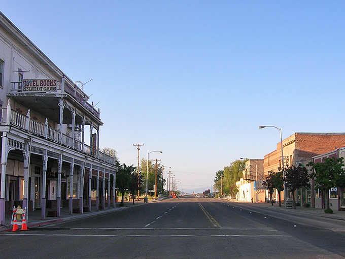 Main Street stretches toward the horizon like a scene from an old Western. The Hotel Rooms sign promises accommodations with history instead of cookie-cutter comfort.