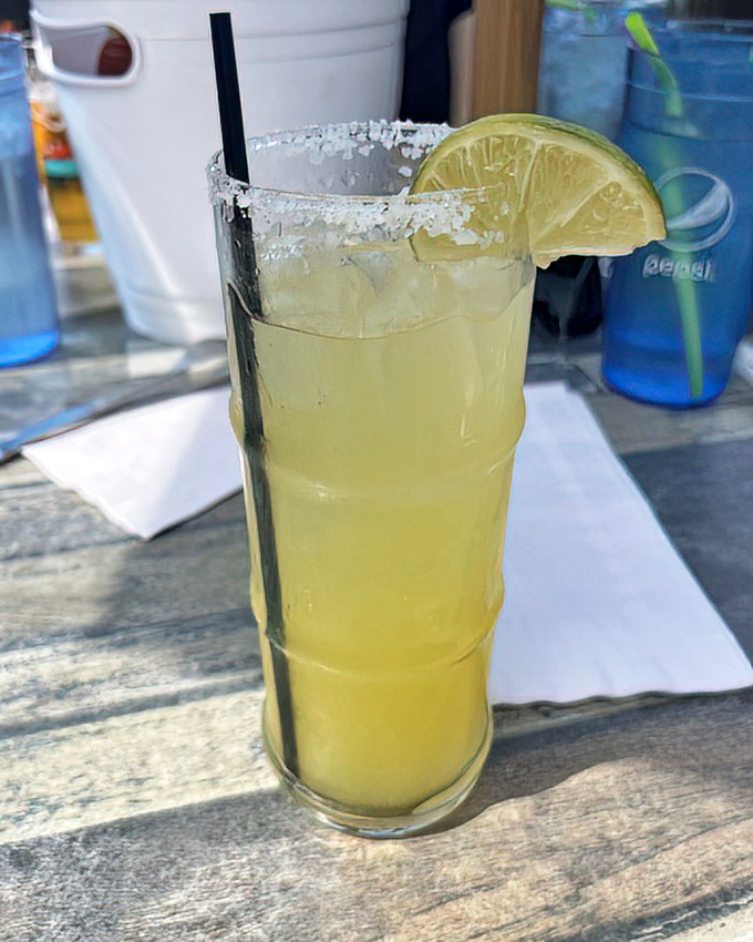 Their margarita arrives with a salt-crusted rim and lime wedge standing guard&mdash;a refreshing companion to cut through the richness of fried seafood delights.