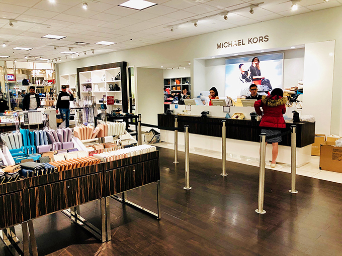 Michael Kors: where luxury handbags are displayed like museum pieces, except here, you're actually encouraged to take them home.