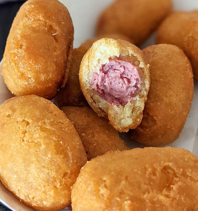 Mini corndogs reveal their pink interior secrets&mdash;crispy outside, savory inside, and altogether too easy to keep popping into your mouth.