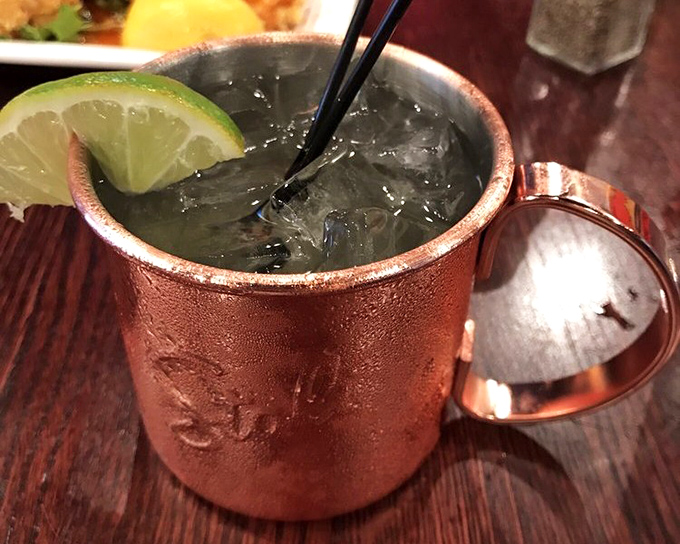 The Moscow Mule comes in its traditional copper mug, condensation beading like it's nervous about how quickly you'll enjoy it.