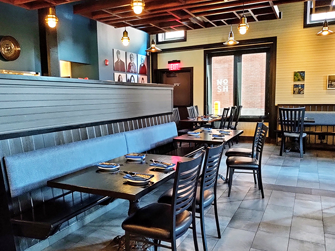 Inside Nosh Scratch Kitchen, the warm wood and blue accents create an atmosphere where comfort meets culinary creativity without pretension.