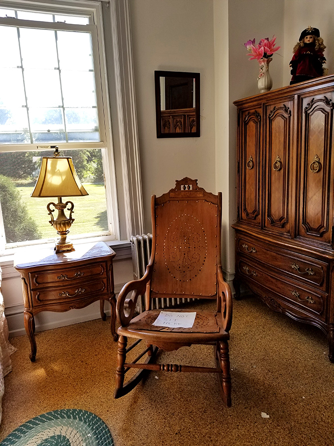 A rocking chair sits patiently by the window, as if its former occupant just stepped away momentarily and might return any second.