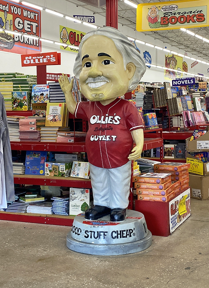 The Ollie's mascot stands guard over the book section like a bargain-hunting deity. His knowing smile says, "Yes, these prices are really real."