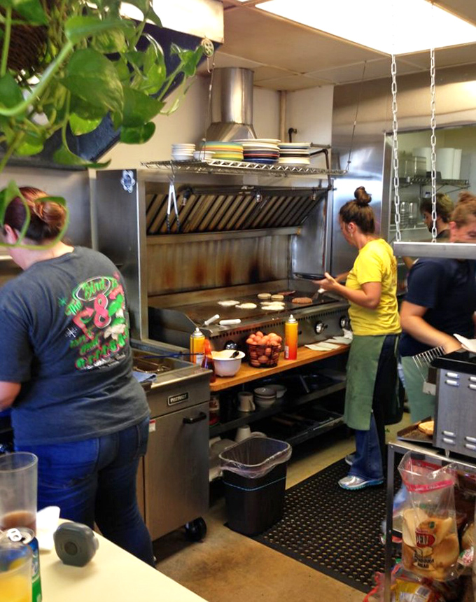 The open kitchen reveals the choreographed dance of breakfast preparation&mdash;pancakes hitting the griddle as eggs sizzle nearby.