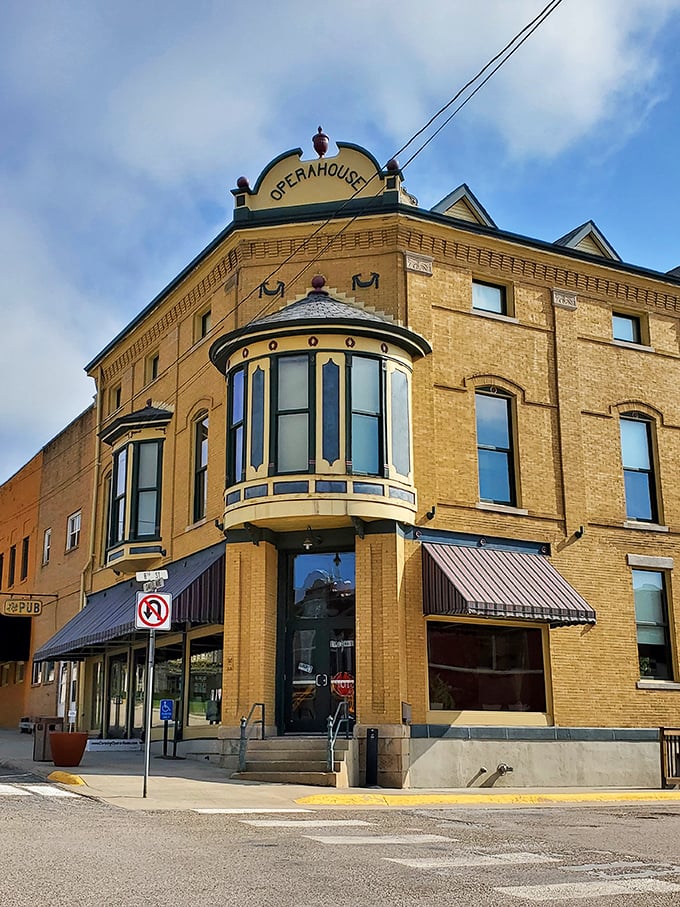 The historic Opera House anchors the corner with architectural grandeur, its curved bay windows watching over generations of Corning residents.