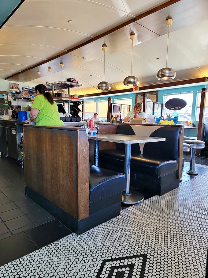 The heart of any great diner is its bustling kitchen area. Those pendant lights aren't just illuminating the space&mdash;they're spotlighting culinary magic in progress.