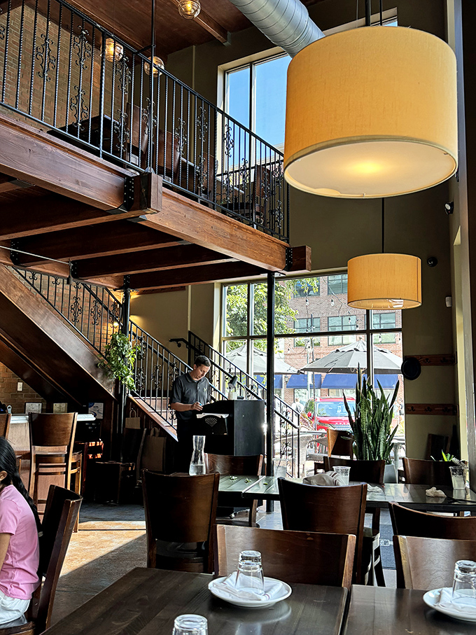 Soaring ceilings, drum pendant lights, and those gorgeous wooden beams create a space that feels both intimate and expansive—like a really good conversation.