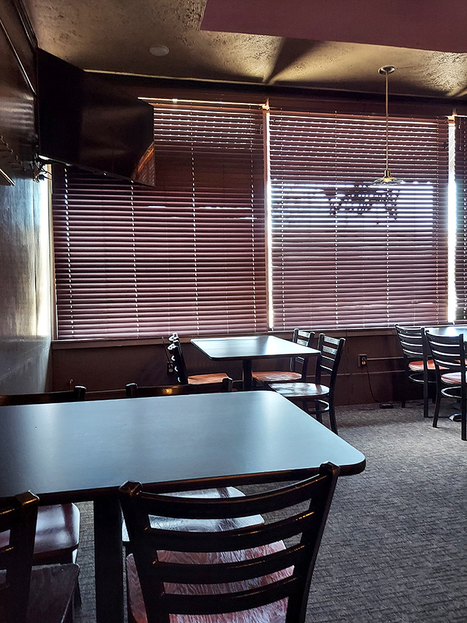 Sunlight filters through blinds like nature's own Instagram filter. These tables have hosted first dates, last meals, and everything between.