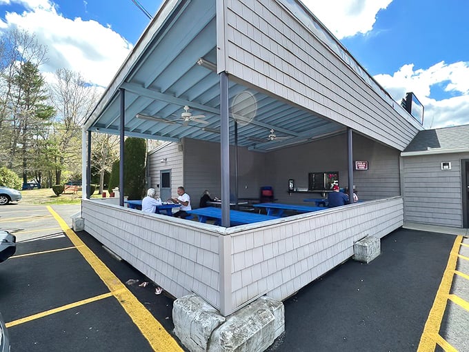 Kay's covered outdoor seating area offers the perfect shelter for seafood enjoyment, rain or shine. These blue tables have witnessed countless "mmms" of satisfaction.
