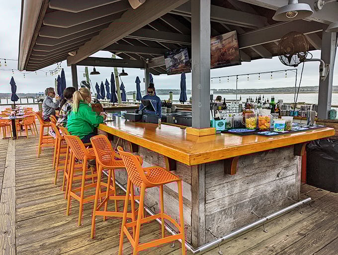 An outdoor bar where the ocean breeze mixes your drink for free and conversations flow as easily as the tide. 