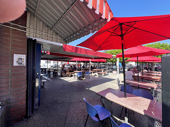 Red umbrellas and picnic tables under California sky&mdash;outdoor dining doesn't need to be fancy to be perfect.