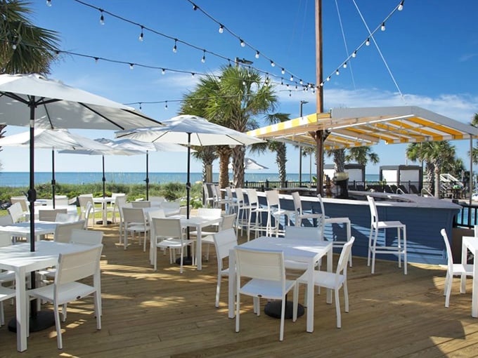 Al fresco dining with string lights and sea breezes. This outdoor deck captures the essence of coastal dining &ndash; casual elegance with your toes practically in the sand.