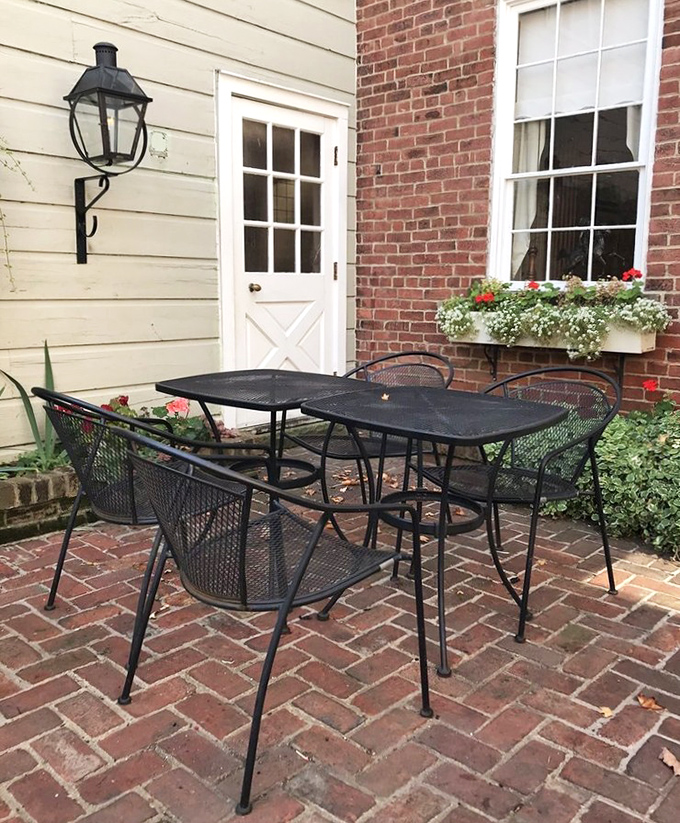 Outdoor dining with brick pathways and flower boxes &ndash; suburban paradise meets colonial charm.