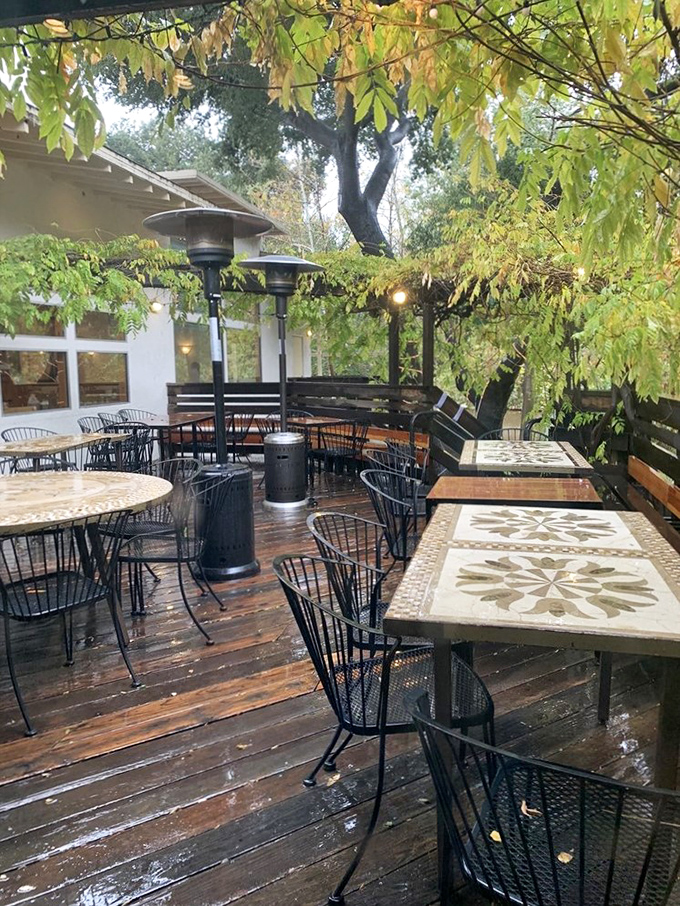 The outdoor patio whispers "stay awhile" under a canopy of oak leaves, where California weather meets French dining sensibilities.