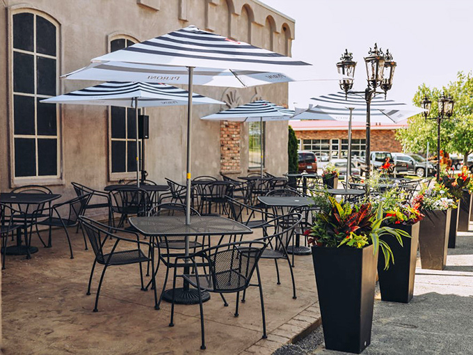 The outdoor patio offers al fresco dining with striped umbrellas and planters—bringing a touch of Italian piazza to the Illinois heartland.