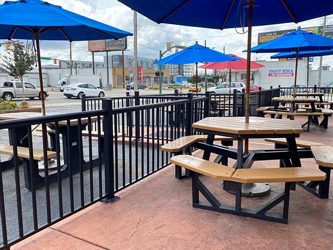 The outdoor seating area—where vitamin D meets vitamin B(urger) under cheerful blue umbrellas that match the Virginia sky.