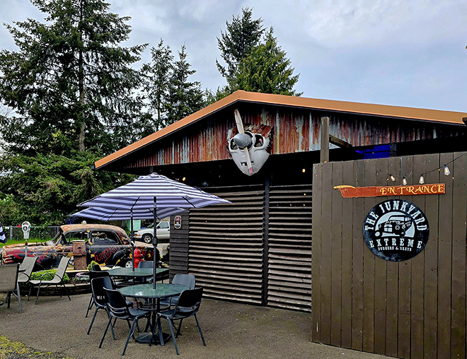 Outdoor seating with a side of actual junk&mdash;including what appears to be a partial car. Authenticity you can't manufacture, only accumulate. 
