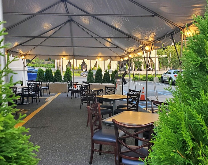Outdoor dining under a tent that transforms a parking lot into an al fresco experience. Nature meets pancakes in perfect harmony.