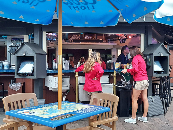The outdoor bar serves as command central for summer socializing, where lake views and cold drinks form the foundation of perfect Minnesota afternoons.