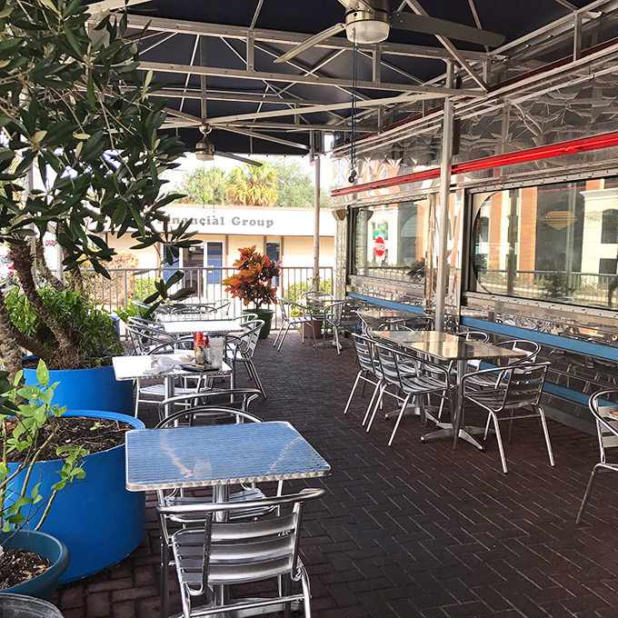 The outdoor patio offers al fresco dining with a side of Florida sunshine—metal chairs gleaming like they're auditioning for a 1950s sitcom set.