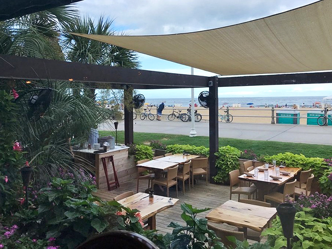 Outdoor dining with ocean breezes as a complimentary side&mdash;nature's air conditioning paired with front-row views of boardwalk life.