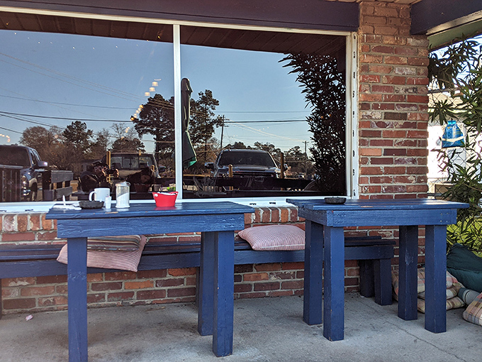 Blue wooden outdoor tables offer fresh air dining where you can watch the world go by between bites of country ham.