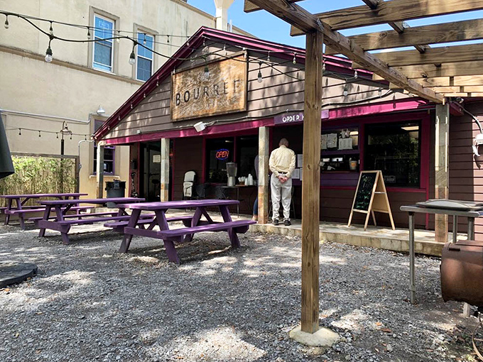 Purple picnic tables under string lights create the perfect setting for memory-making. Food always tastes better with a side of fresh air.