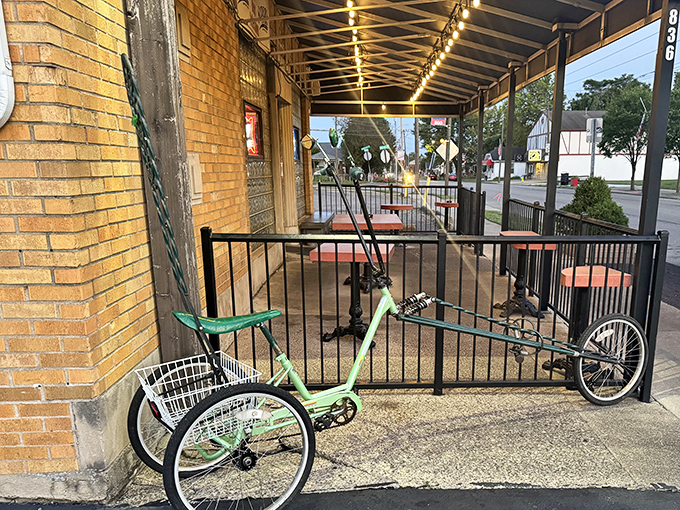 The covered porch offers al fresco dining with a side of people-watching&mdash;and that green tricycle has probably heard some stories.