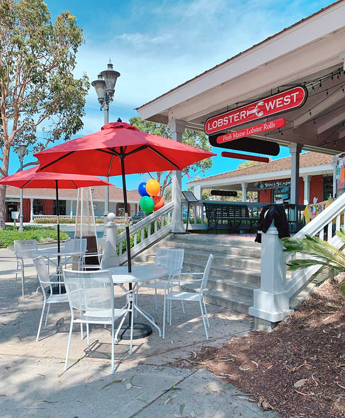 Outdoor seating under cheerful red umbrellas offers the perfect spot for people-watching while savoring ocean treasures. California sunshine included at no extra charge.