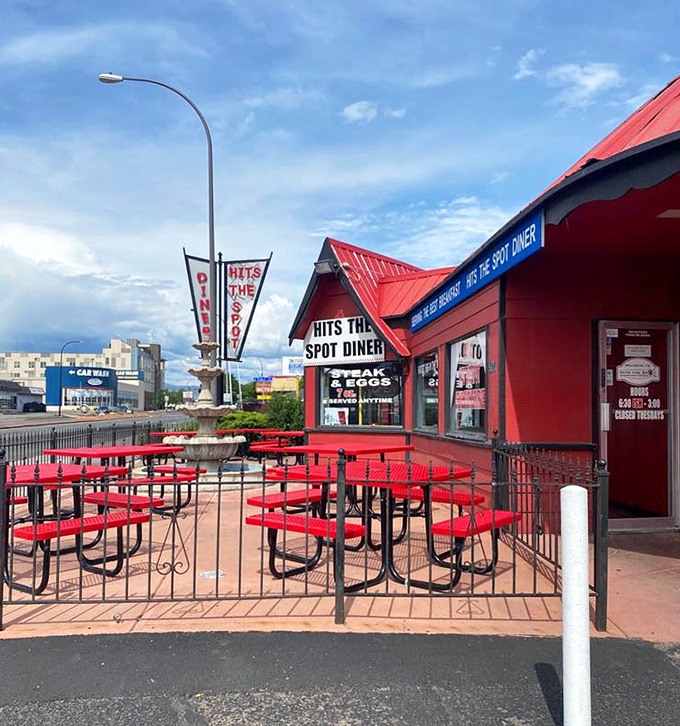Al fresco dining, diner-style: red metal tables under Colorado's blue skies, perfect for enjoying breakfast while contemplating absolutely nothing important.