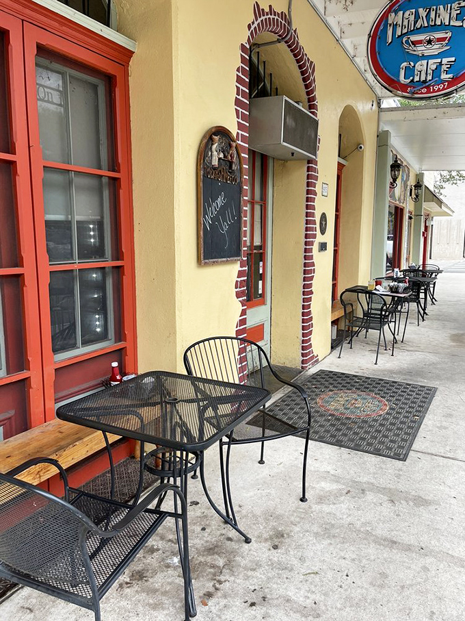 Sidewalk seating that invites you to watch Bastrop life unfold while savoring your meal. Those red-trimmed windows frame the experience perfectly.