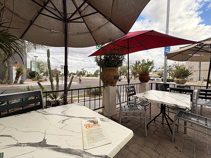 The patio offers front-row seats to Scottsdale's perfect weather, with umbrellas standing guard against the rare rainy day.