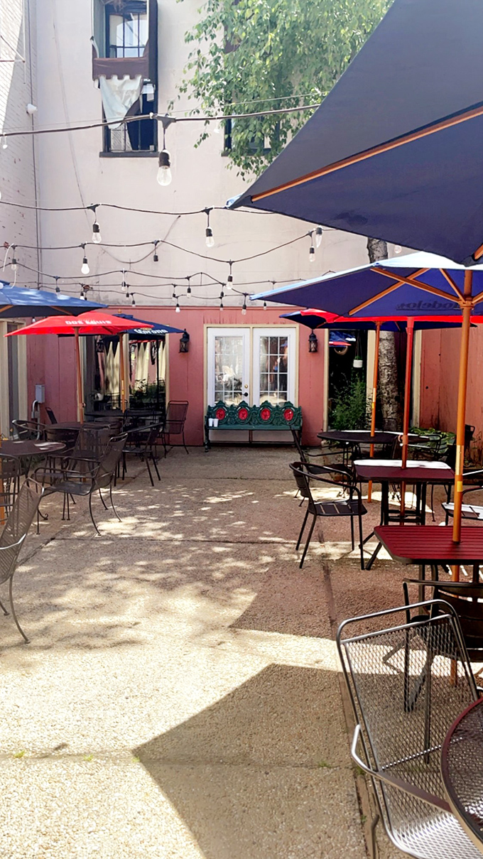 The outdoor patio, strung with twinkling lights, offers a perfect summer escape. Even the umbrellas look like they're having a good time.