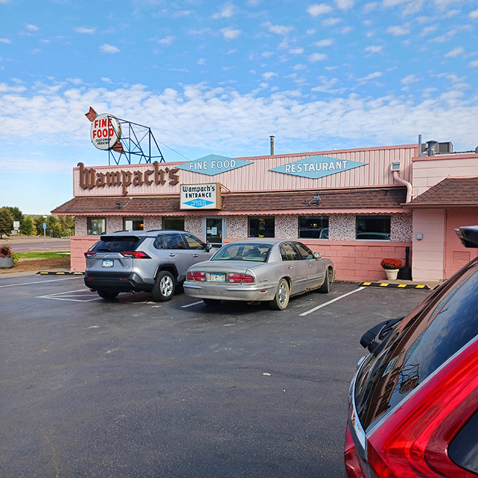 Morning light bathes the pink exterior in a golden glow, turning this humble diner into a beacon of breakfast possibility for early risers.