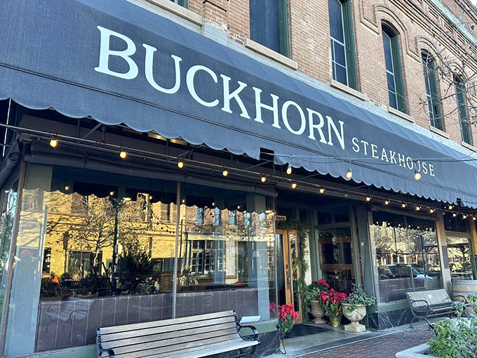 The blue awning announces your arrival at meat paradise. String lights twinkle with promise, while seasonal planters add touches of color to this carnivore's cathedral.