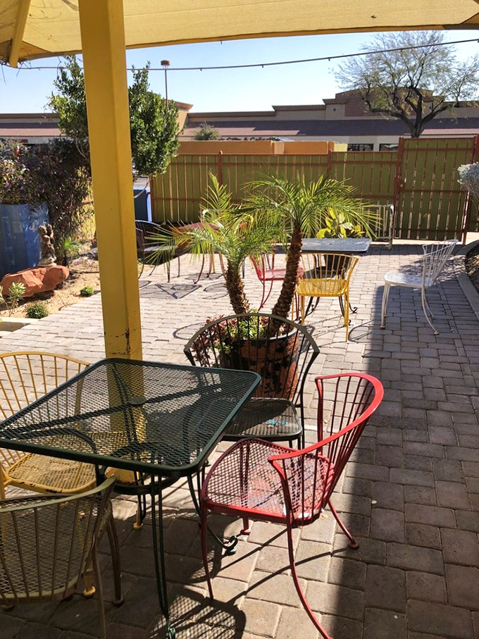 The patio offers desert dining perfection—where colorful chairs invite you to linger over that last bite of burrito.